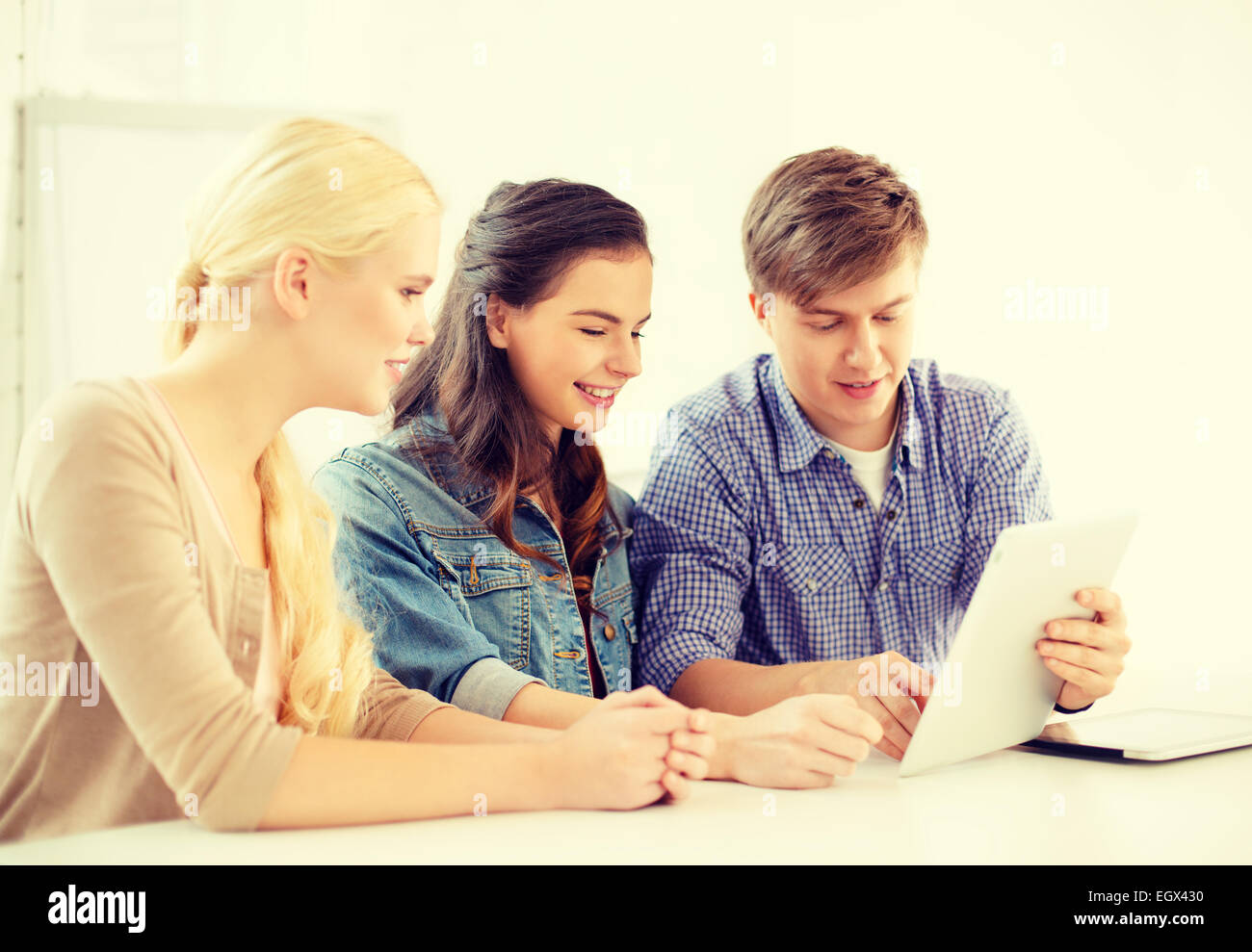 smiling students with tablet pc computer at school Stock Photo - Alamy