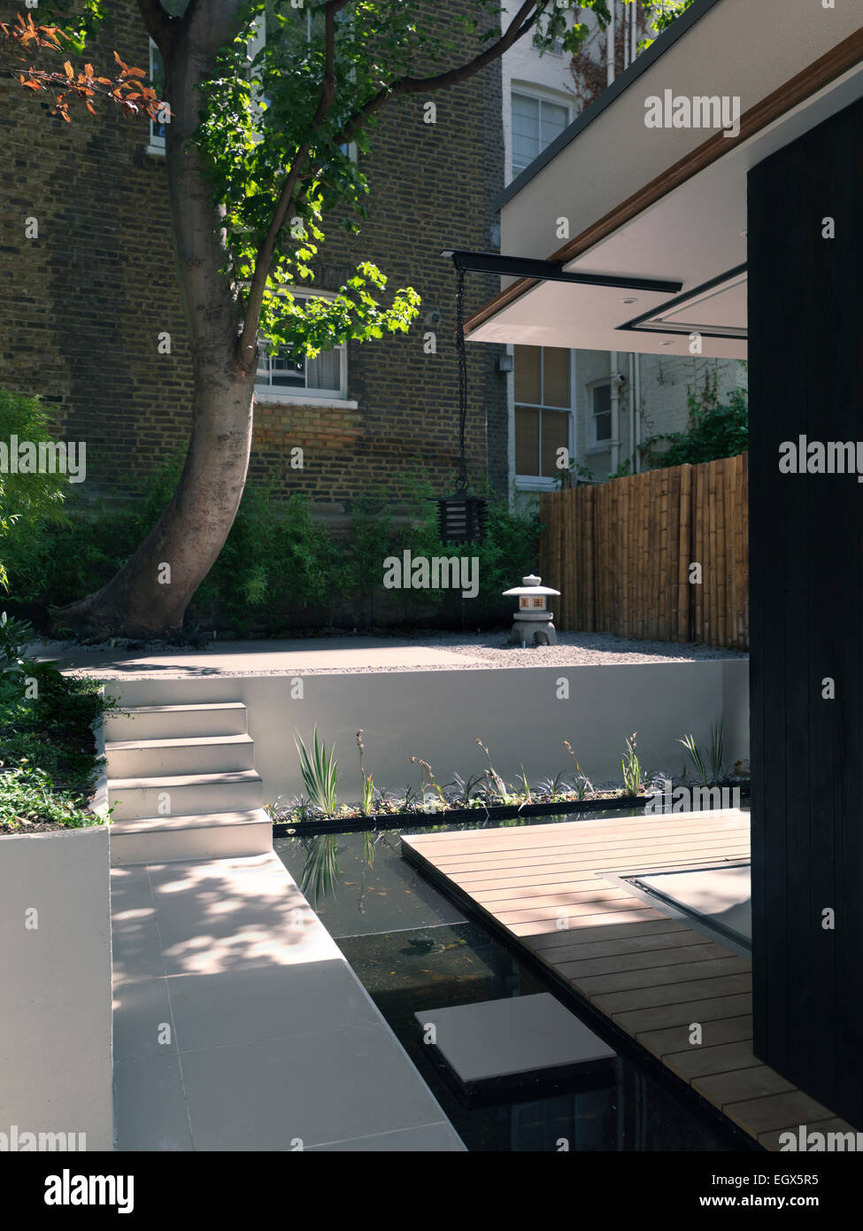 Modern split level garden with pond, UK home Stock Photo - Alamy