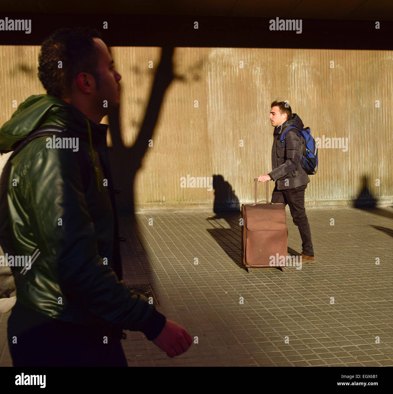 People walking along a wall Stock Photo - Alamy