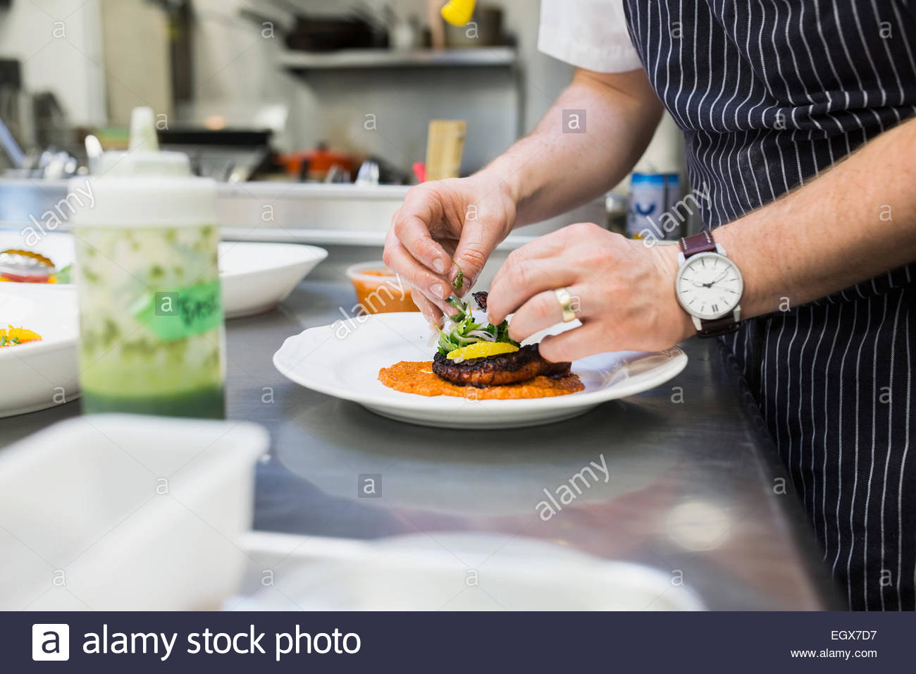 Chef plating food in commercial kitchen Stock Photo - Alamy
