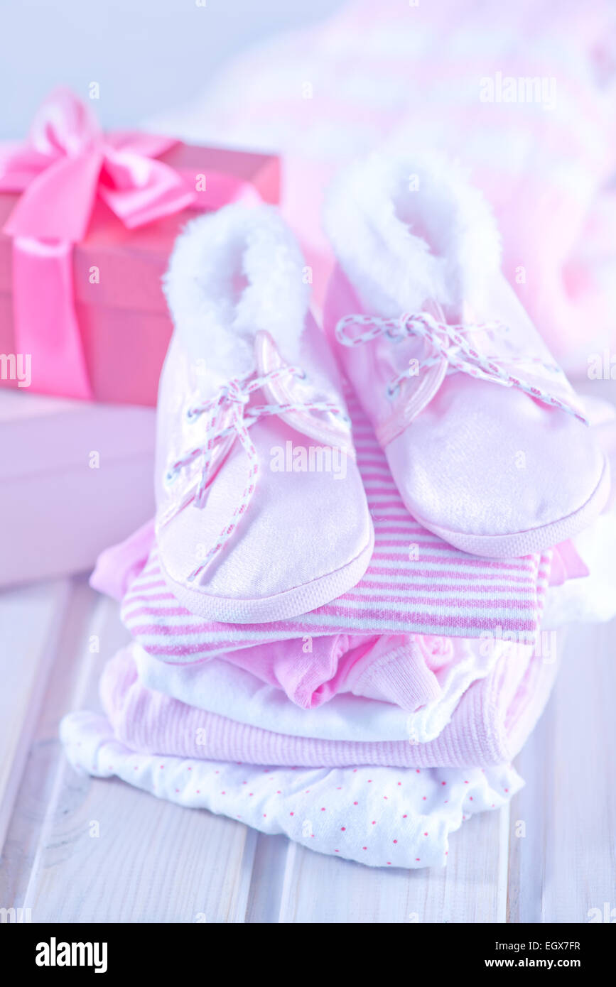 baby clothes for baby girl on a table Stock Photo - Alamy