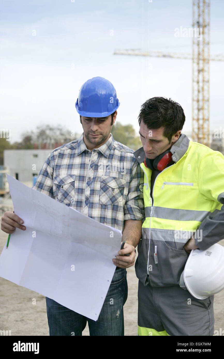 Foreman and colleague checking construction progress Stock Photo - Alamy