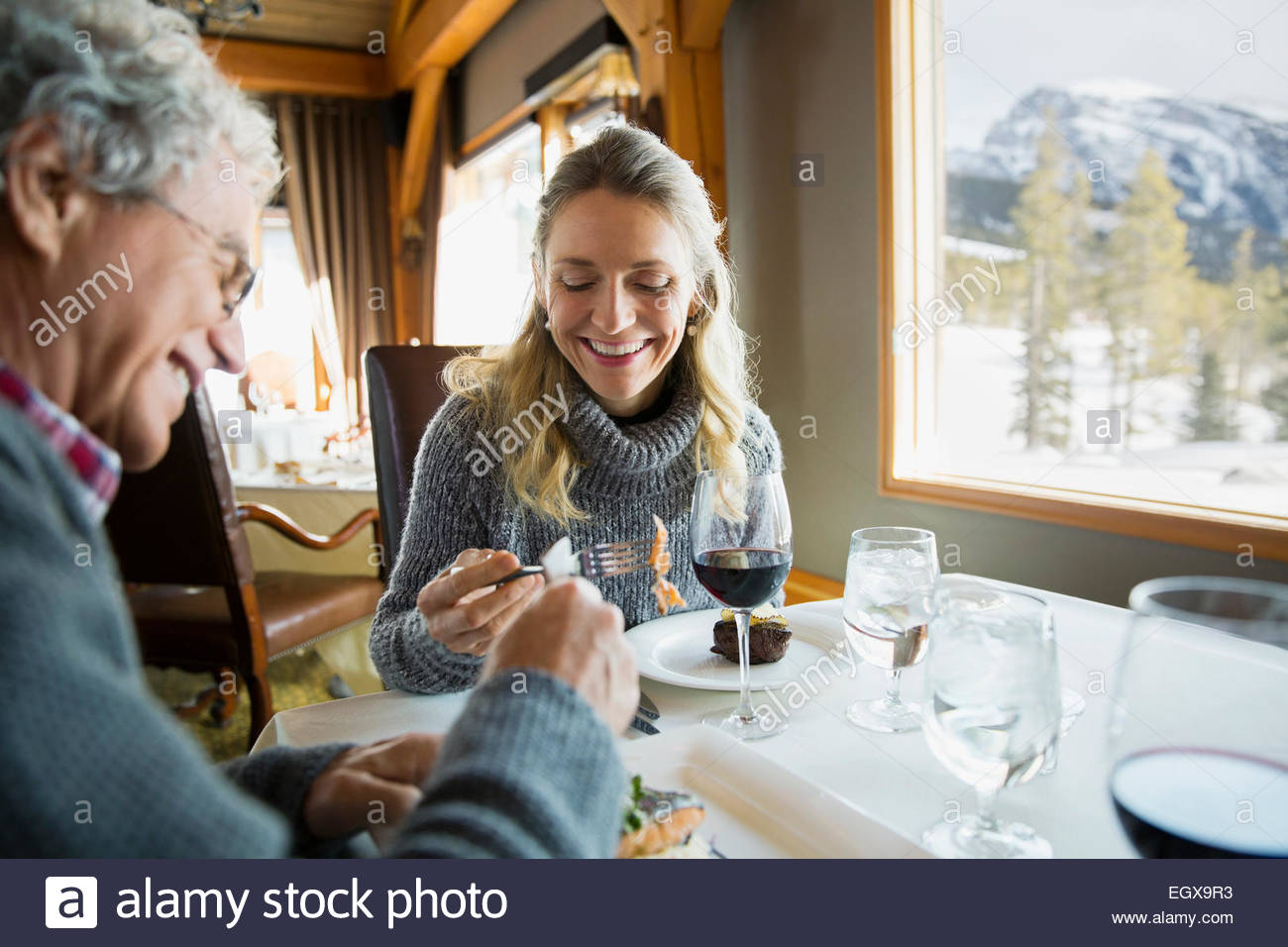 Couple eating at restaurant table Stock Photo - Alamy