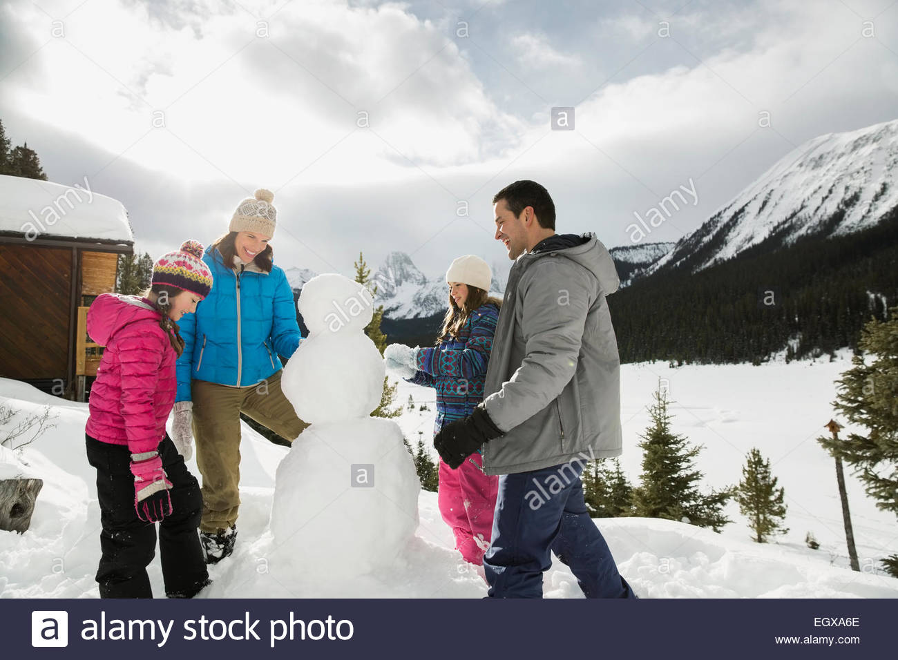 Family with snowman hi-res stock photography and images - Alamy