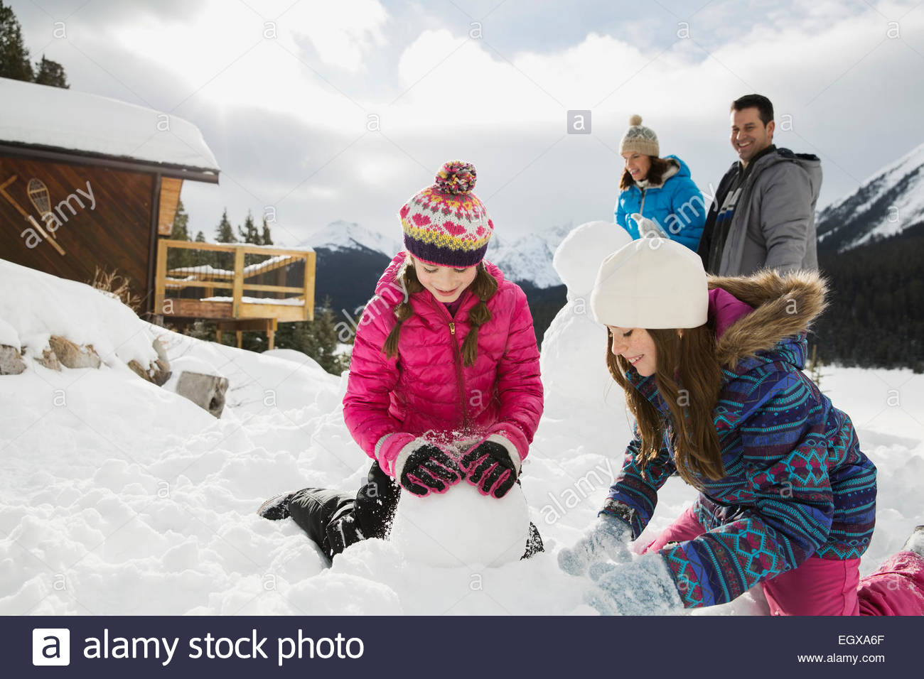 Family making snowman Stock Photo - Alamy