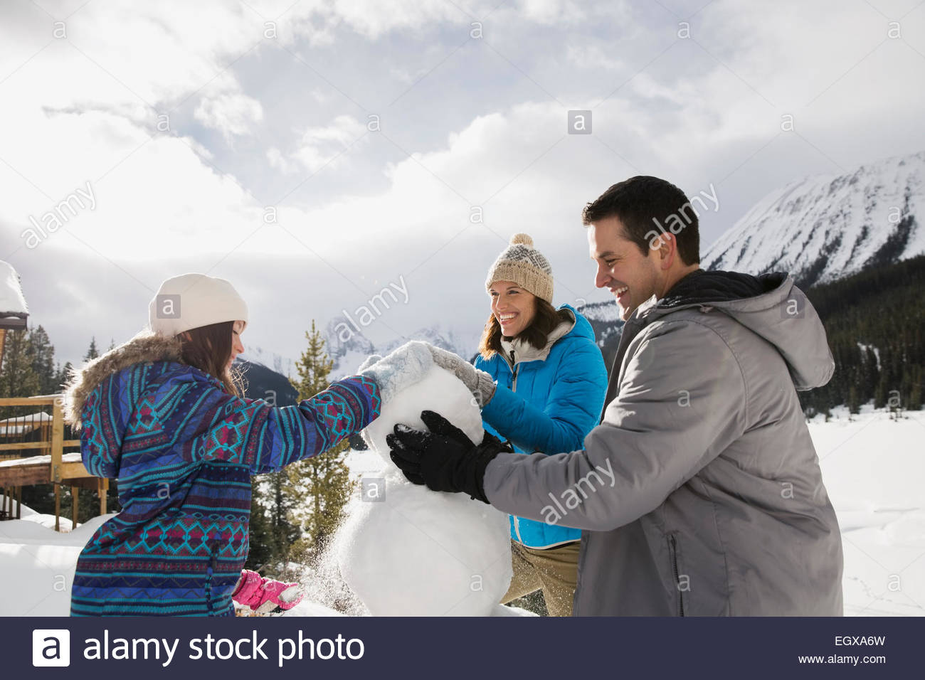 Family with snowman hi-res stock photography and images - Alamy