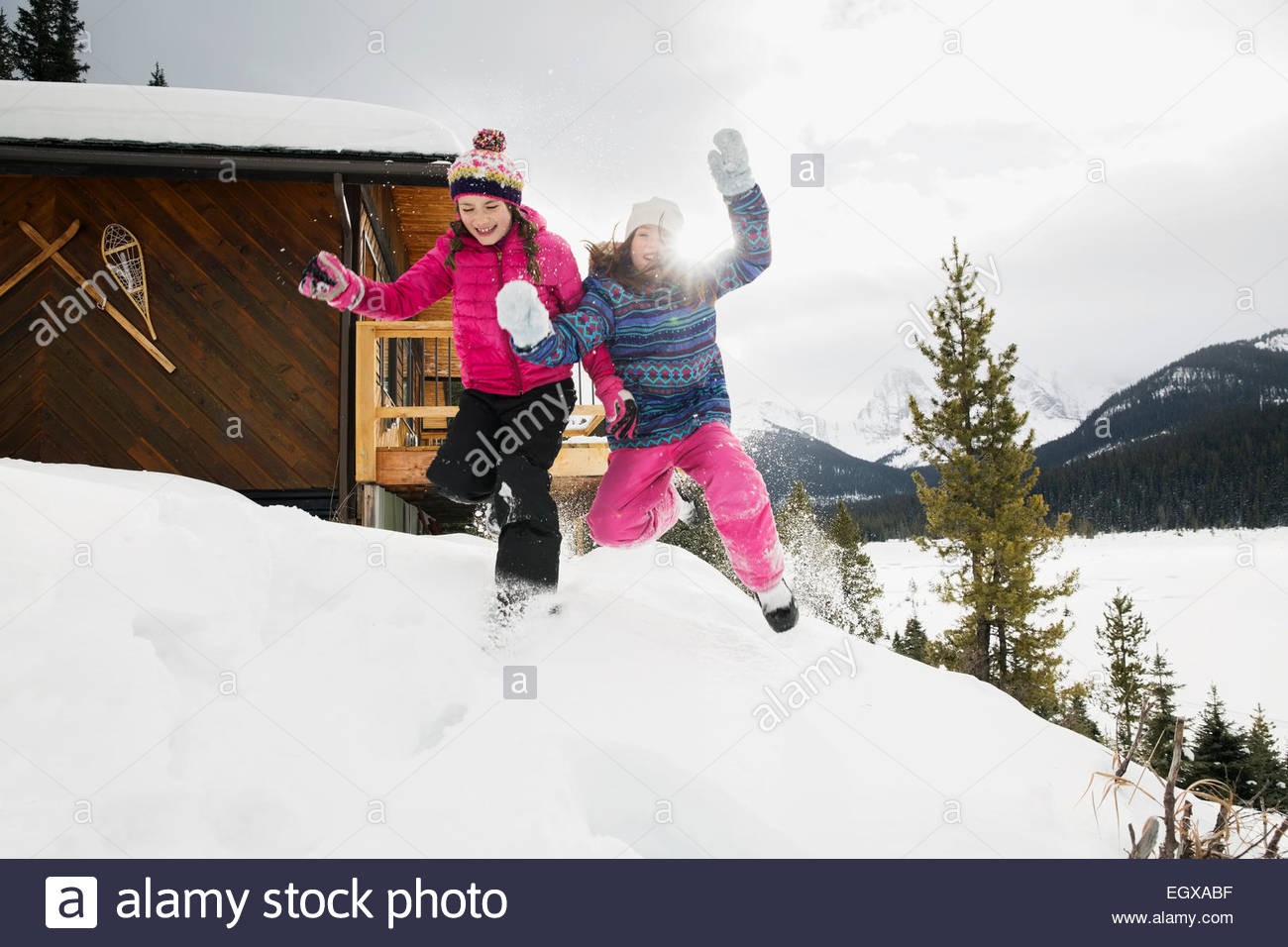 Girl jumping in snow hi-res stock photography and images - Alamy