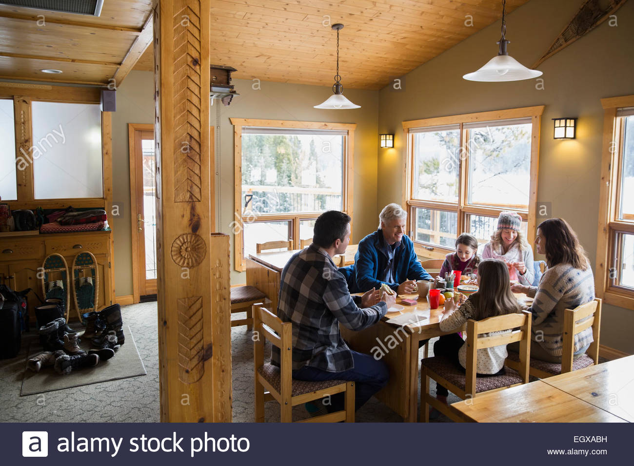Multi generation family sitting around table hi-res stock photography ...