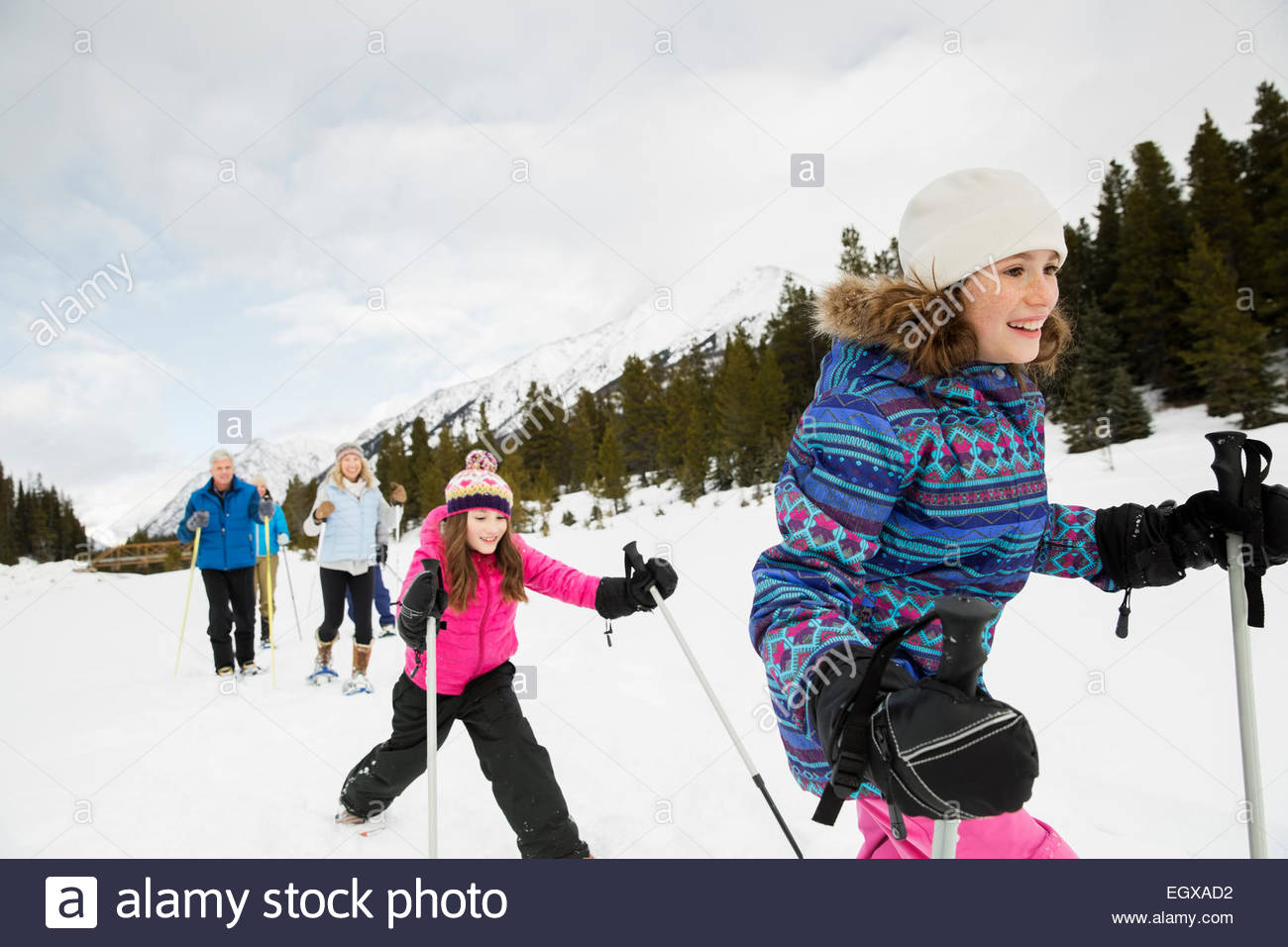 Multi-generation family snowshoeing in field Stock Photo - Alamy