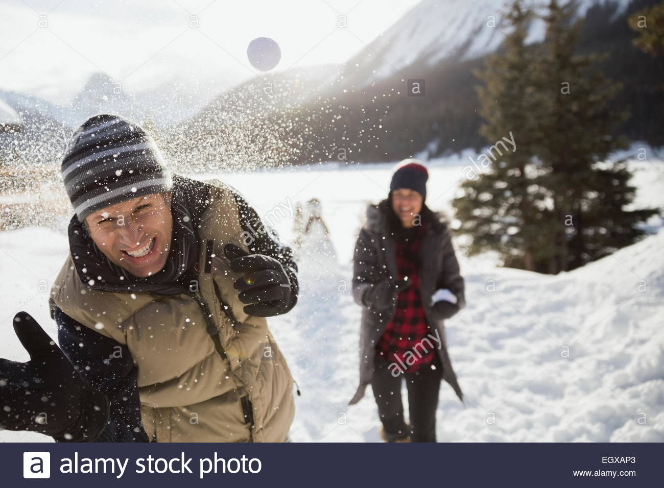 Couple enjoying snowball fight Stock Photo - Alamy