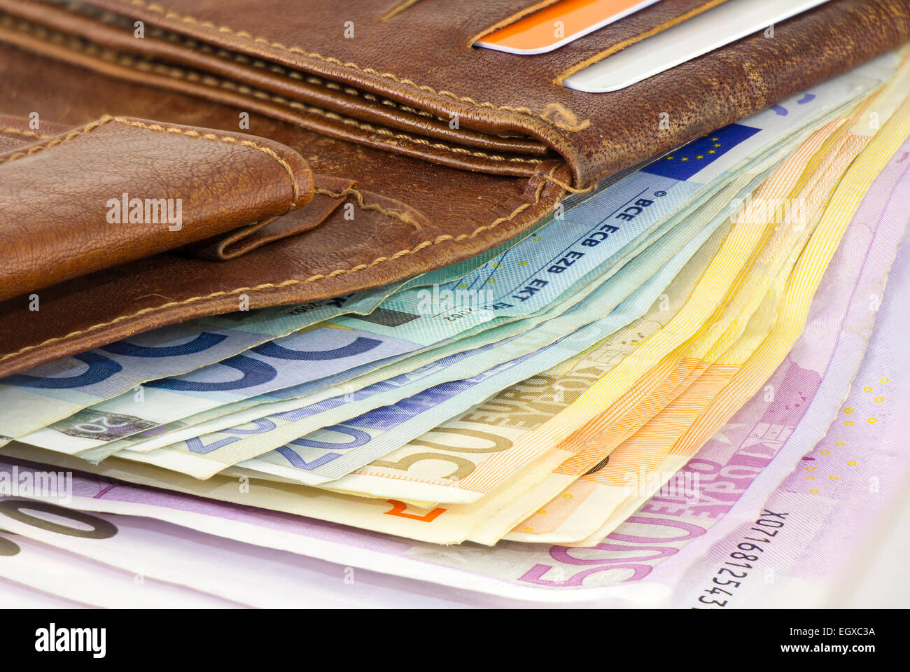 A bundle of Euro banknotes in a brown leather wallet Stock Photo - Alamy