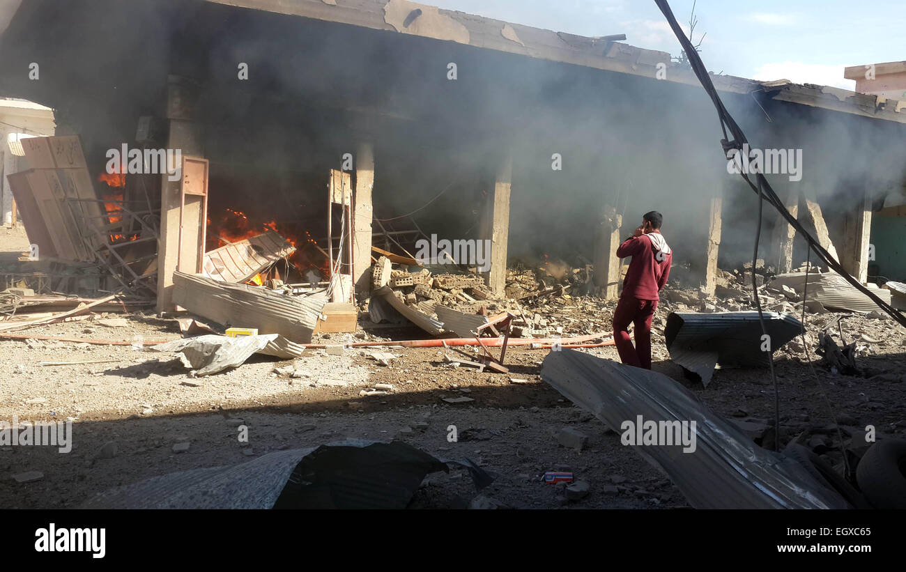 Fallujah, Iraq. 3rd Mar, 2015. A man walks by destroyed buildings after ...