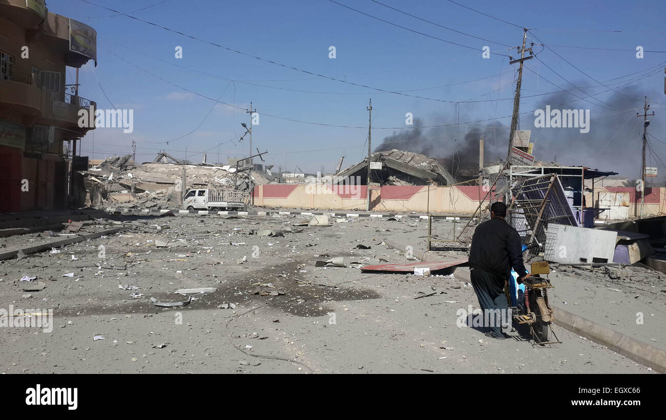 Fallujah, Iraq. 3rd Mar, 2015. A man walks by destroyed buildings after ...