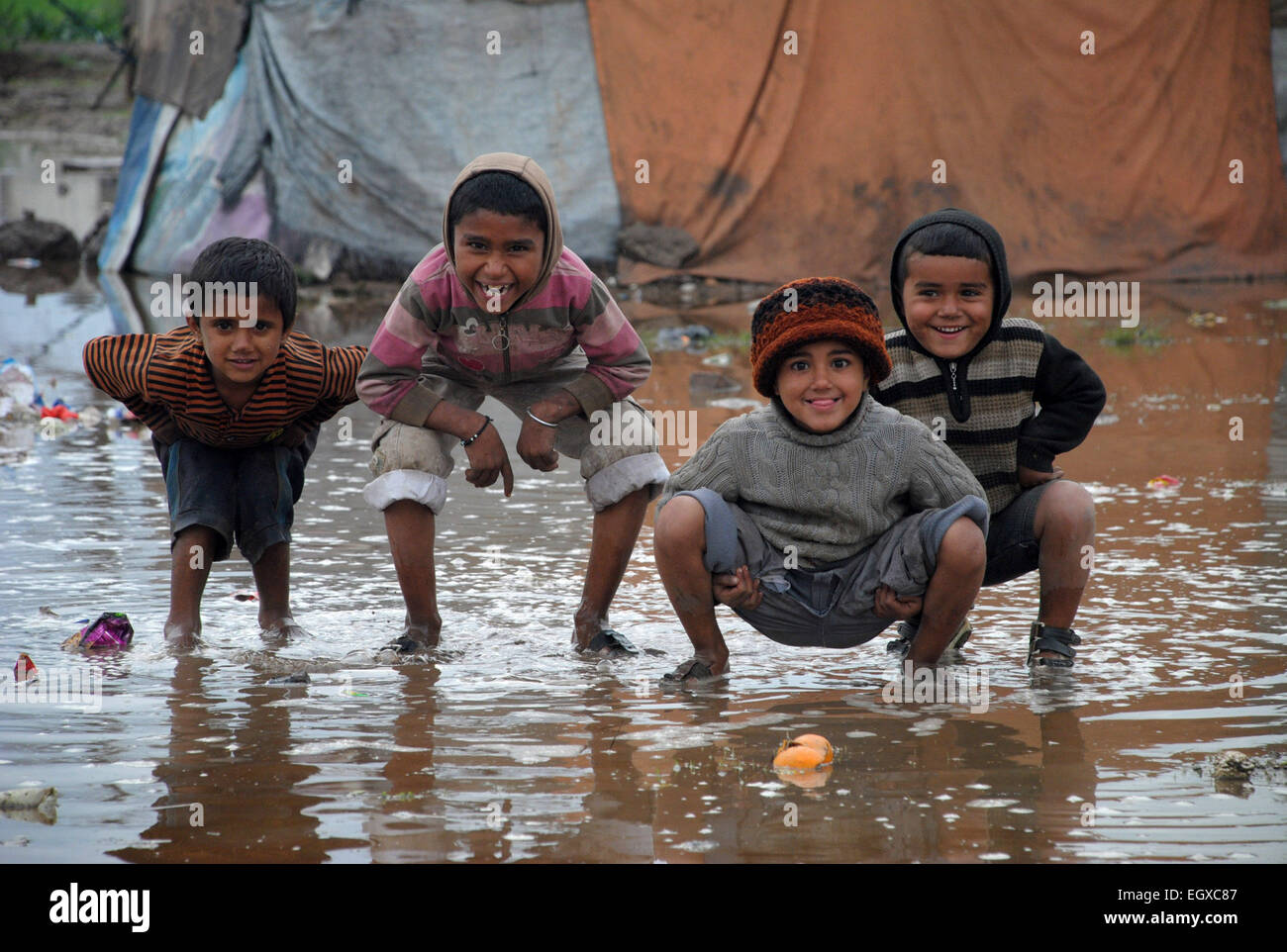 Charsadda. 3rd Mar, 2015. Pakistani boys play in rain water in ...