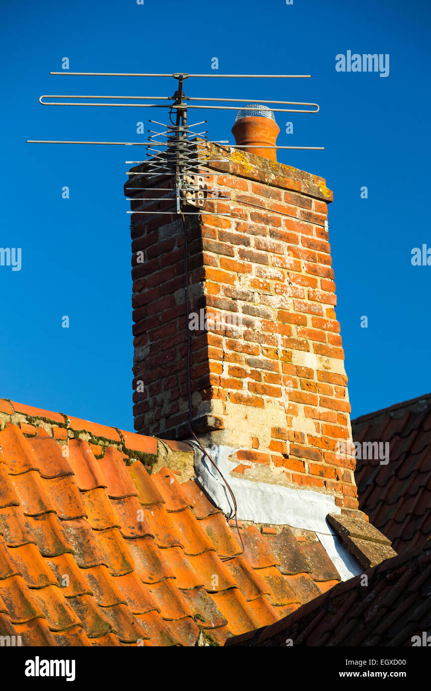 The roof and chimney stack on an old cottage in Cley, Norfolk, UK Stock ...
