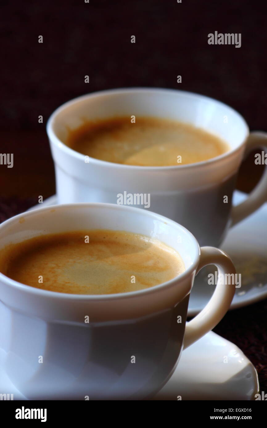 two cups of coffee on a saucer closeup Stock Photo - Alamy