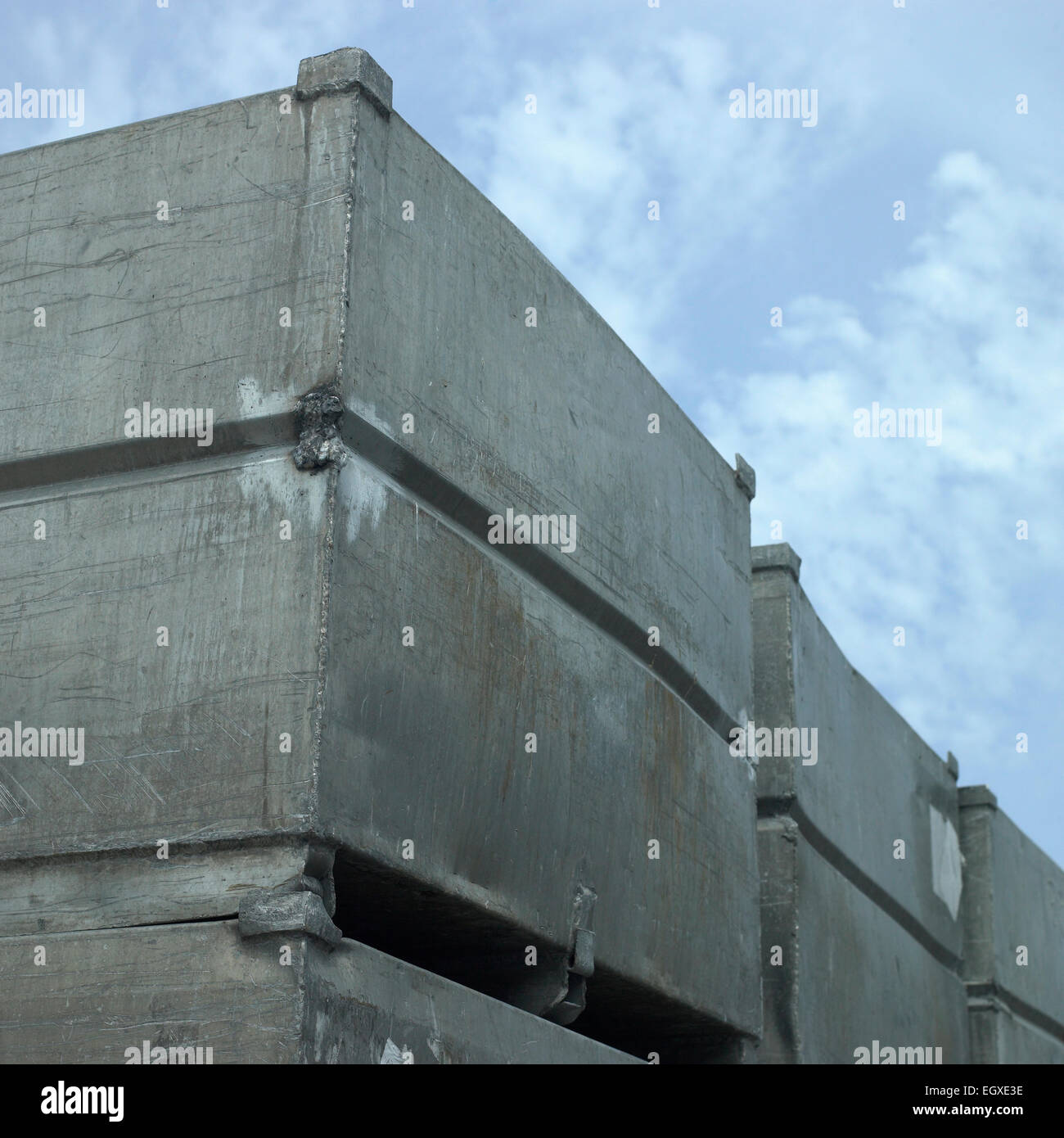 Stacks of large industrial crates against cloudy sky Stock Photo - Alamy