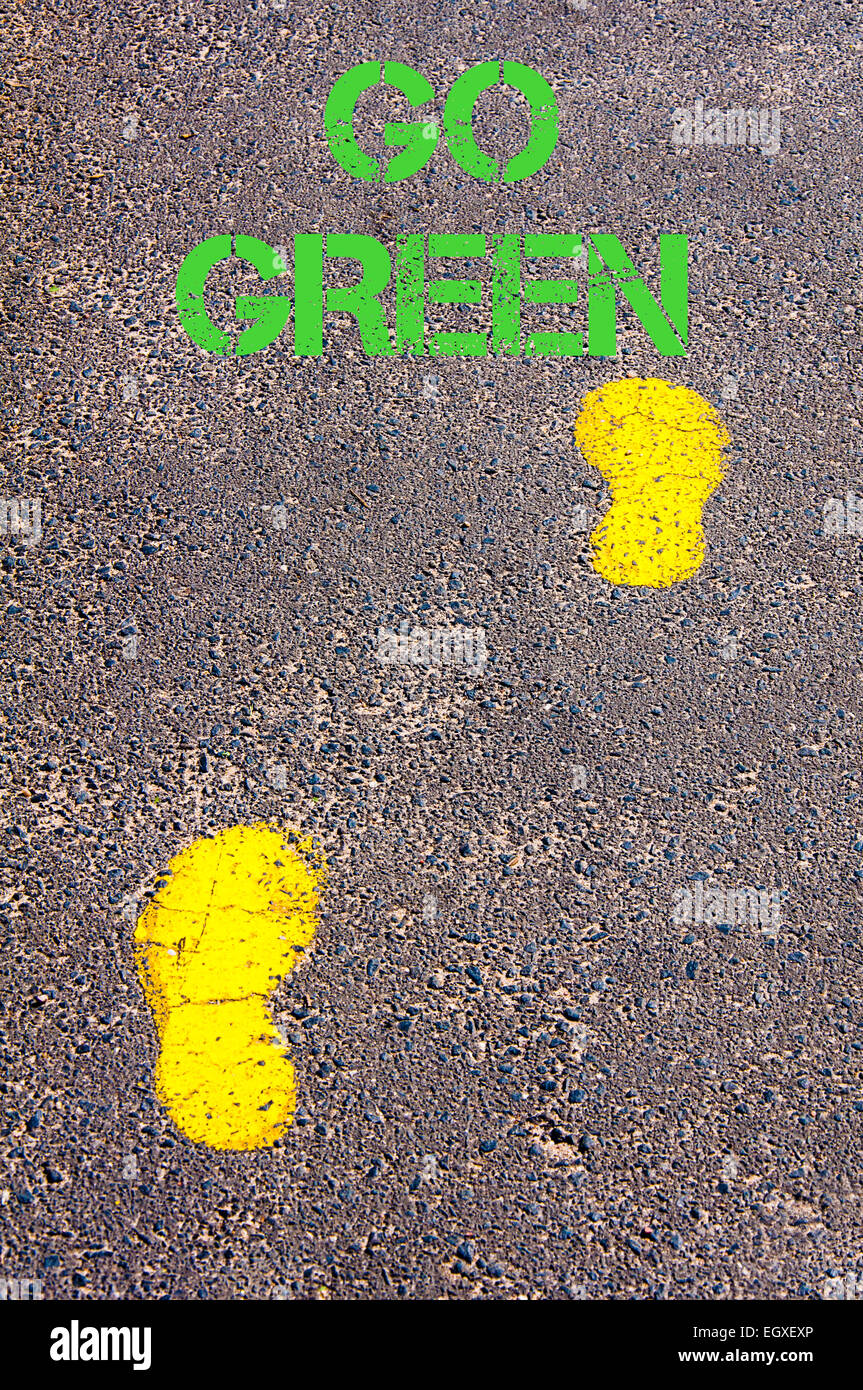 Yellow footsteps on sidewalk towards Go Green message.Conceptual image ...