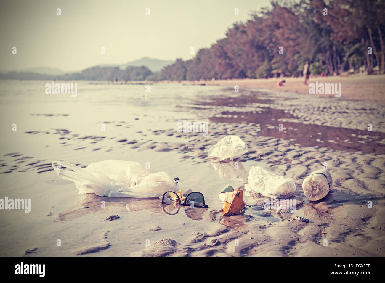 Garbage on a beach left by tourists, environmental pollution concept ...