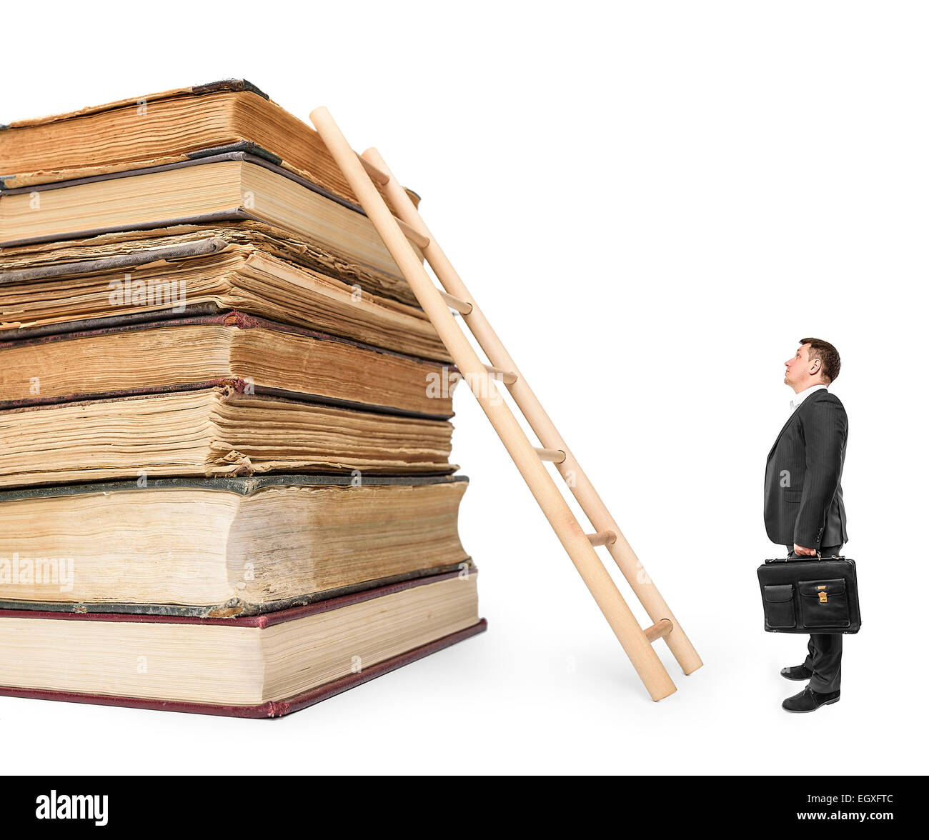 Businessman standing near stack of books Stock Photo - Alamy