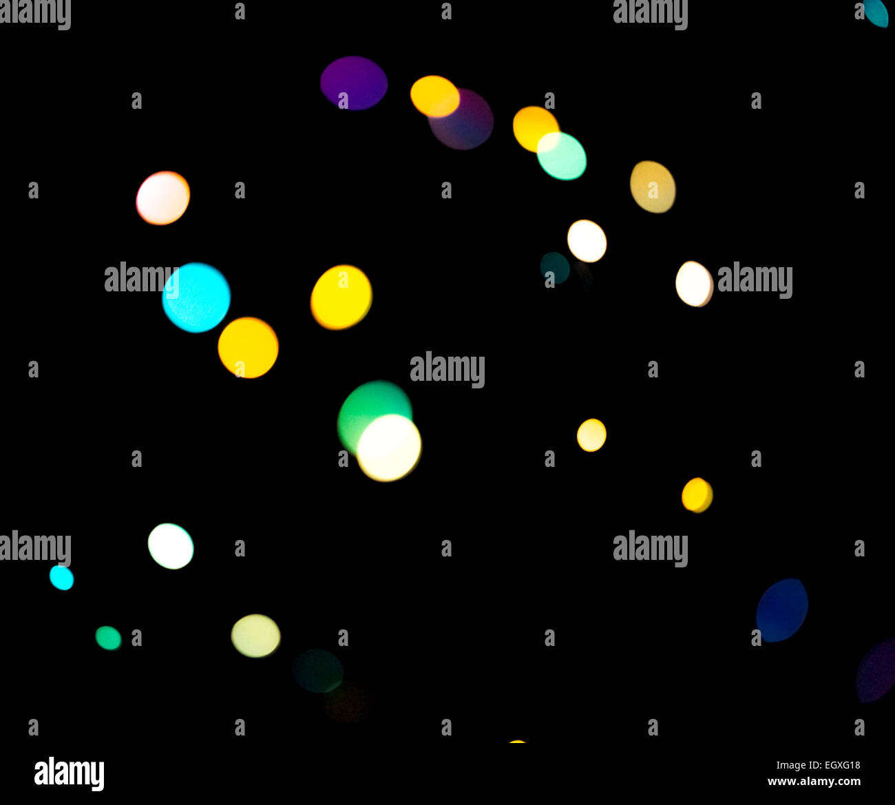 spots of multi coloured light against a black background forming an ...