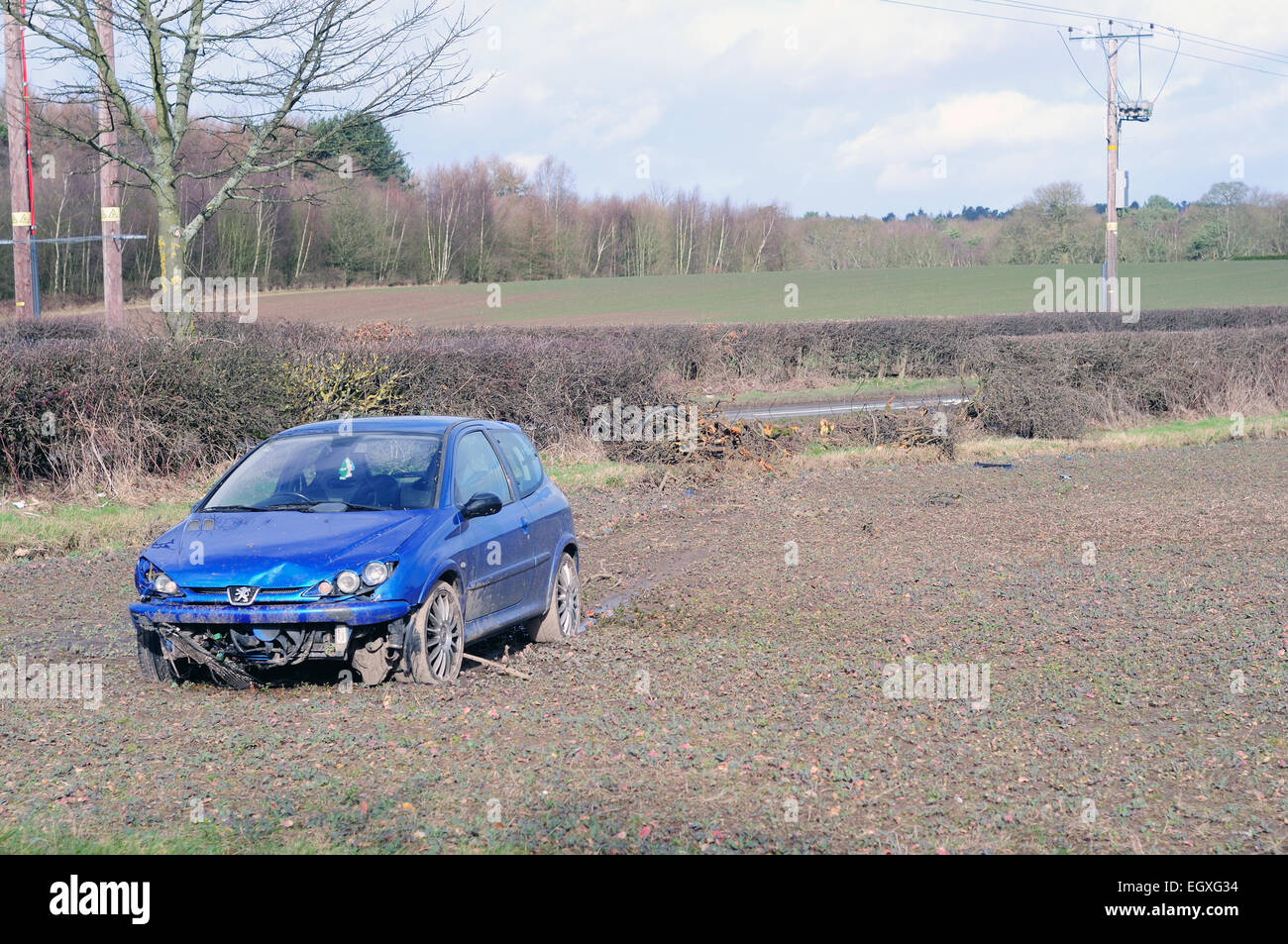 Car Crashed Through Hedge In To Agricultural Field Stock Photo - Alamy