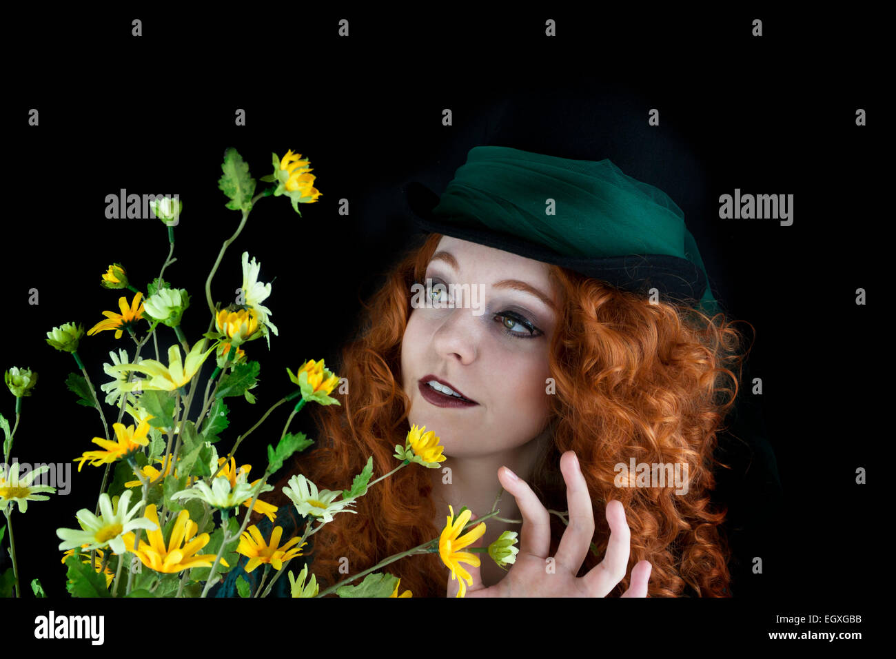 Beautiful young woman wearing top hat with green tulle wrapped abound ...