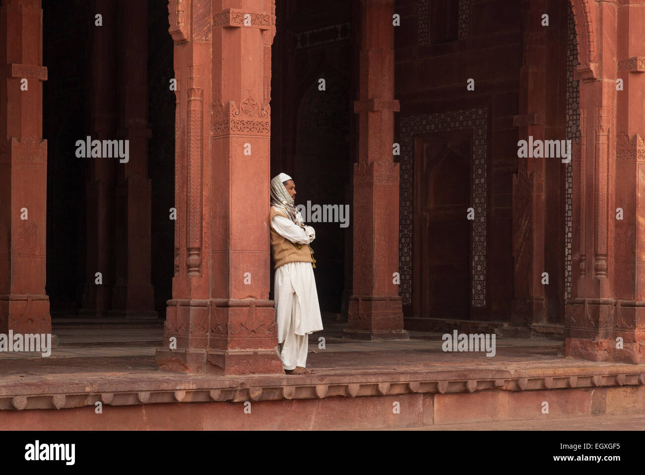 Muslim man standing by a column in Fatehpur Sikri, Uttar Pradesh, India ...
