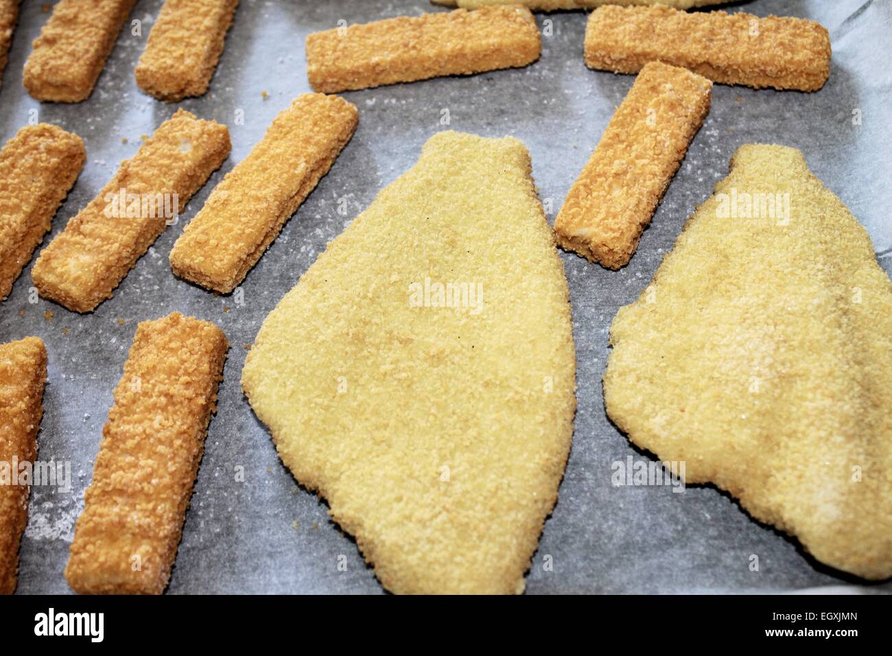 breaded fish on baking paper Stock Photo - Alamy