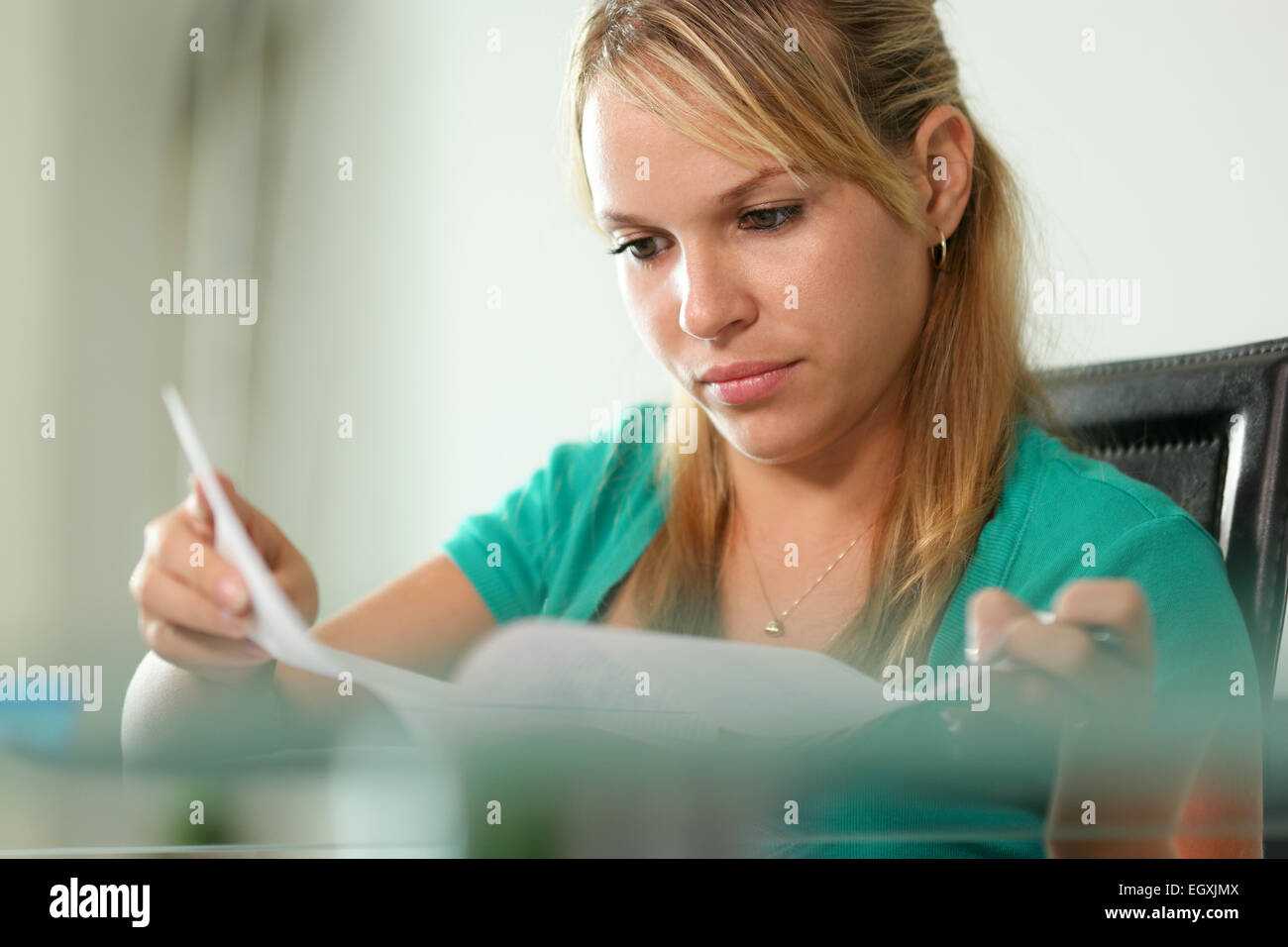 Young blond woman, college student, studying with motivated and ...