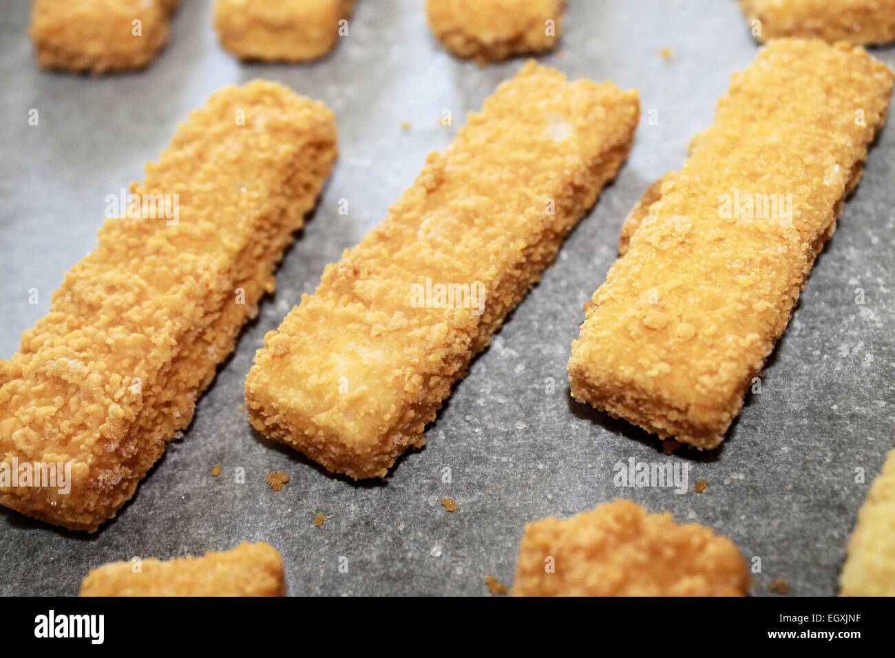 breaded fish on baking paper Stock Photo - Alamy