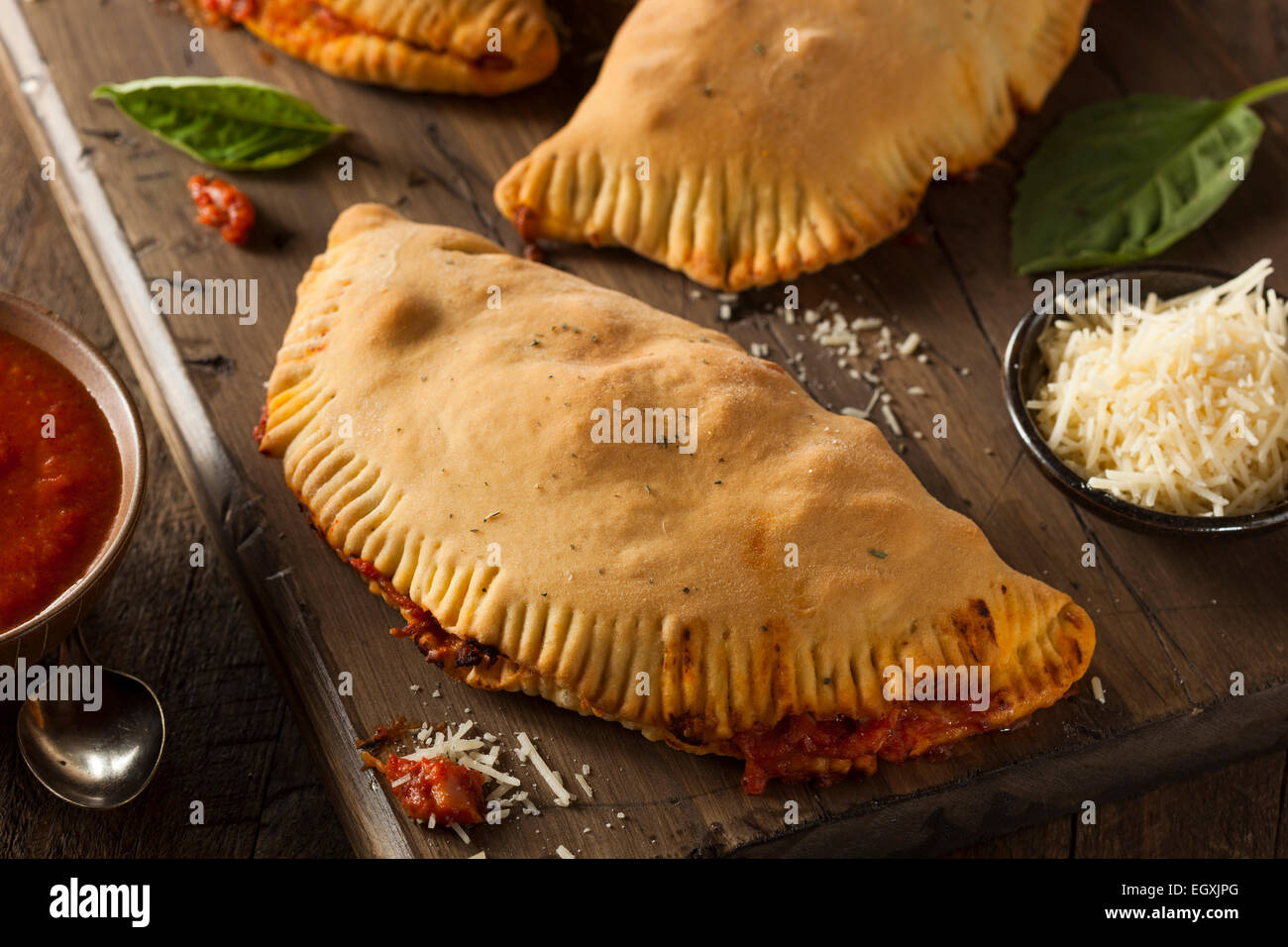 Homemade Italian Meat and Cheese Calzones with Sauce Stock Photo - Alamy