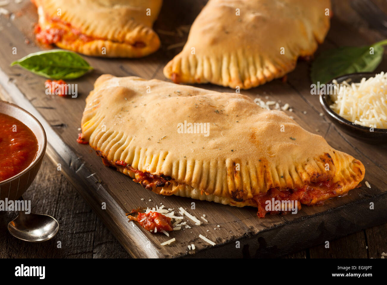Homemade Italian Meat and Cheese Calzones with Sauce Stock Photo - Alamy
