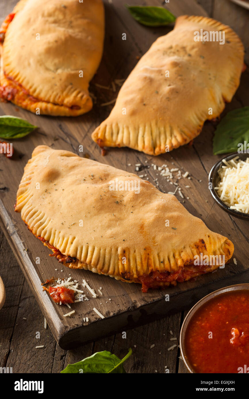 Homemade Italian Meat and Cheese Calzones with Sauce Stock Photo - Alamy