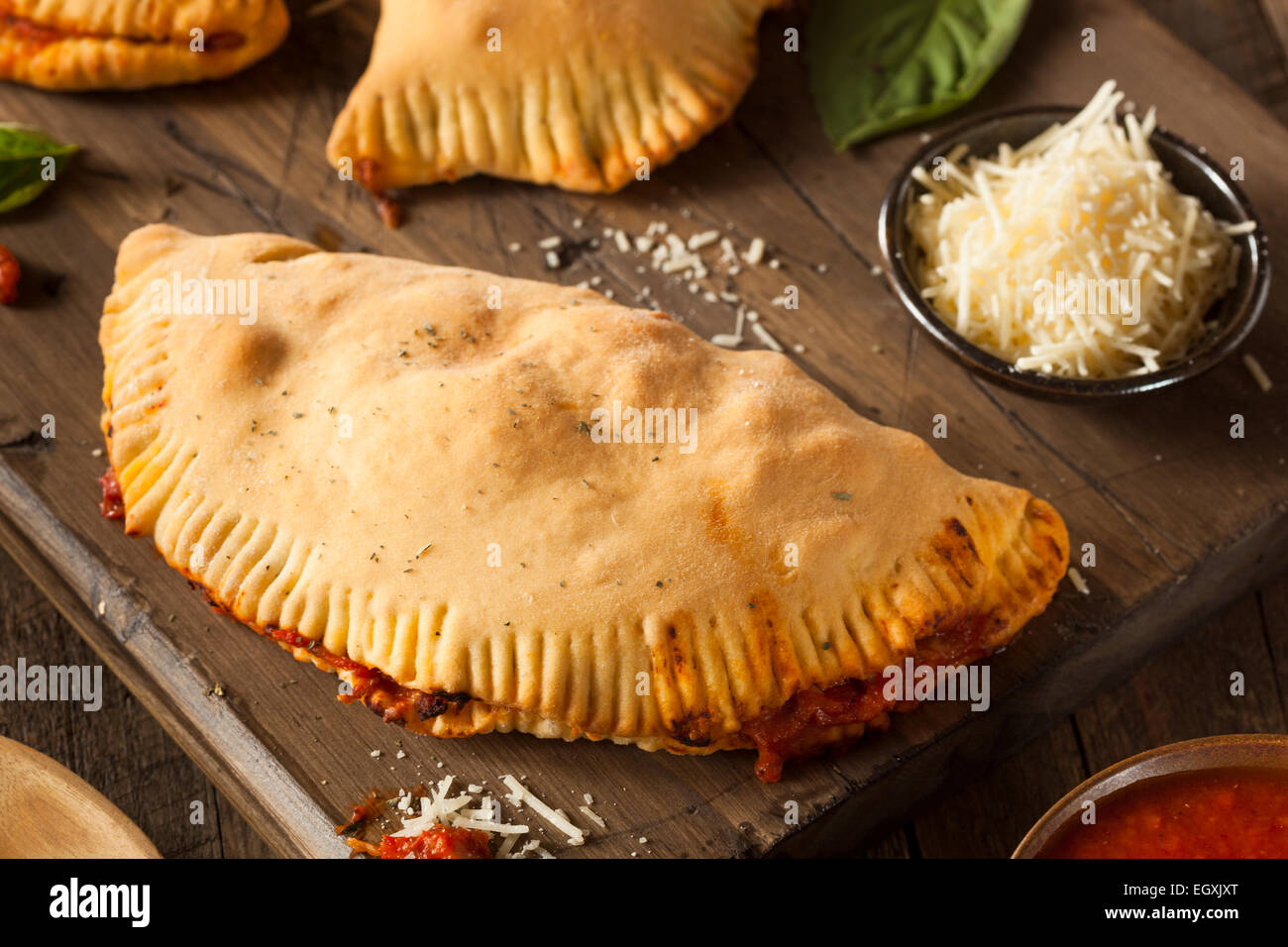 Homemade Italian Meat and Cheese Calzones with Sauce Stock Photo - Alamy