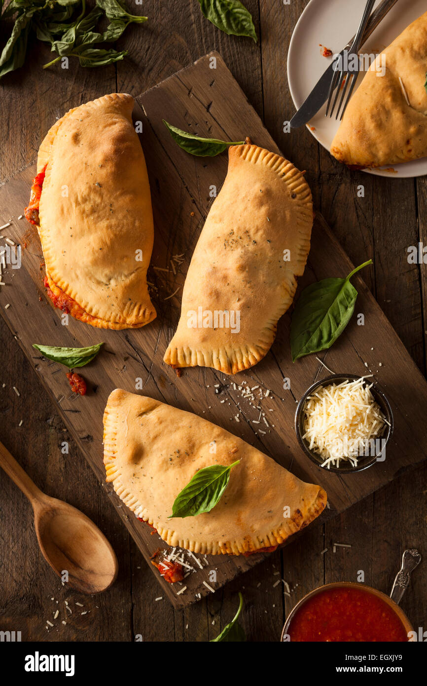 Homemade Italian Meat and Cheese Calzones with Sauce Stock Photo - Alamy