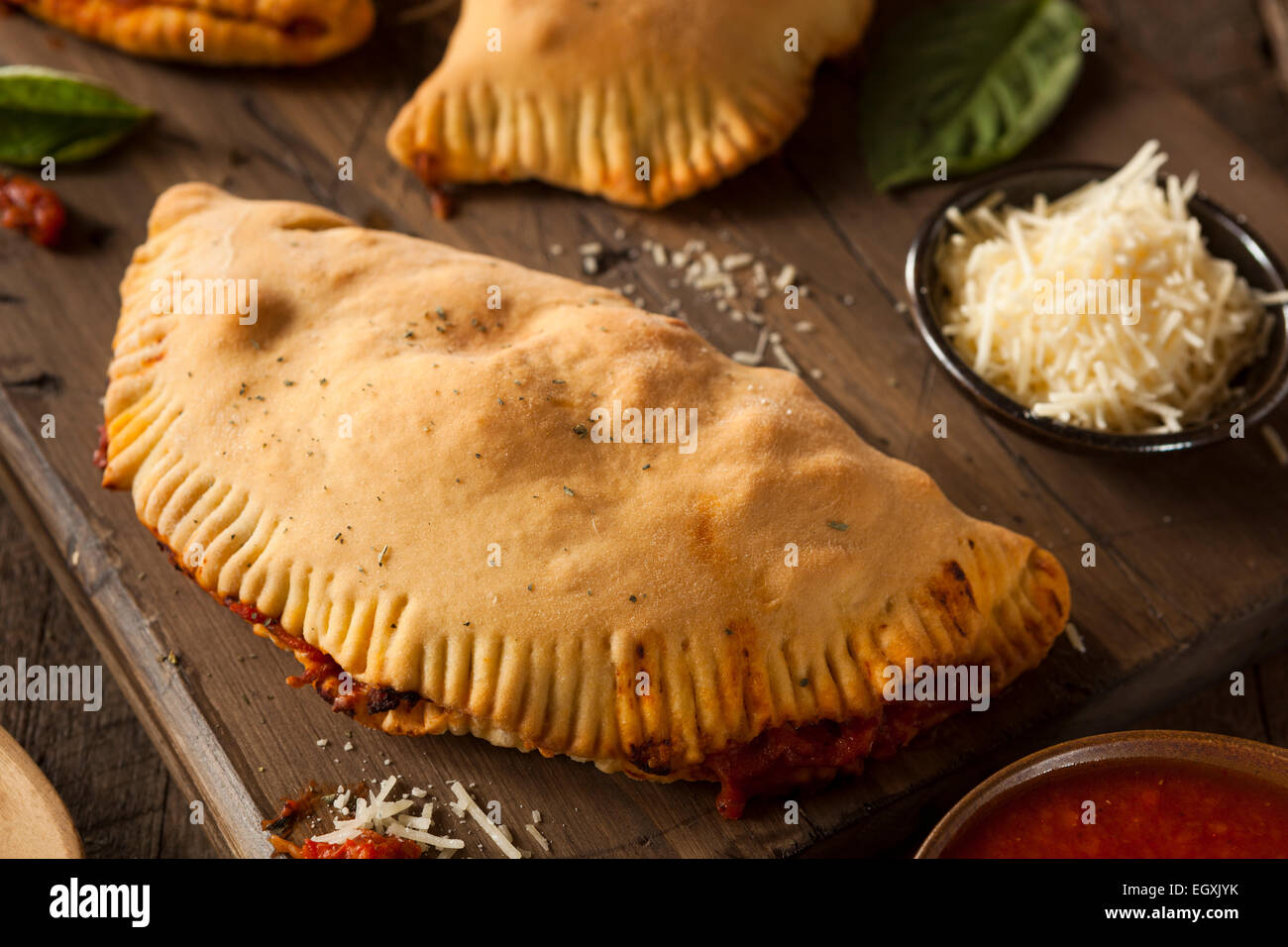 Homemade Italian Meat and Cheese Calzones with Sauce Stock Photo - Alamy