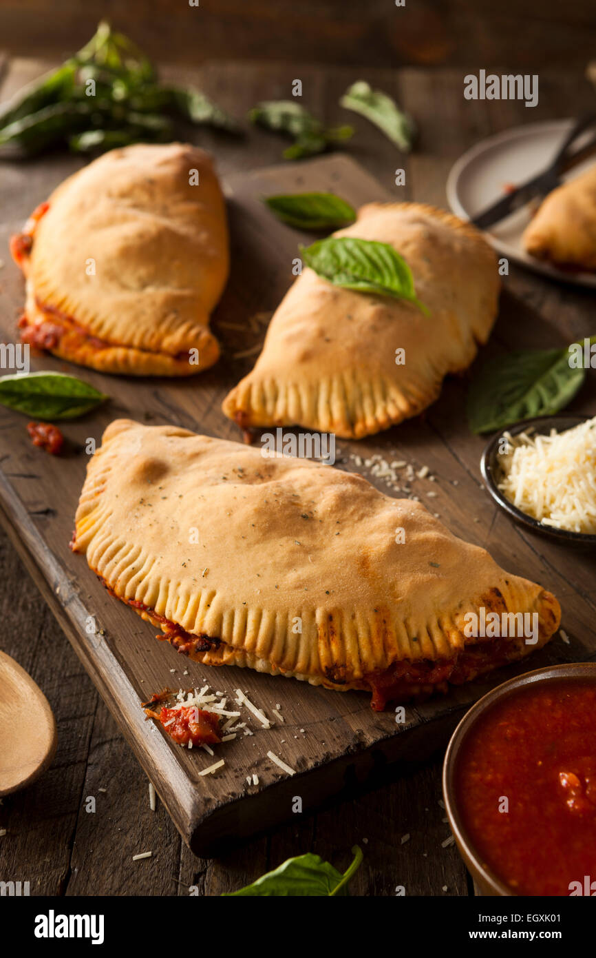 Homemade Italian Meat and Cheese Calzones with Sauce Stock Photo - Alamy