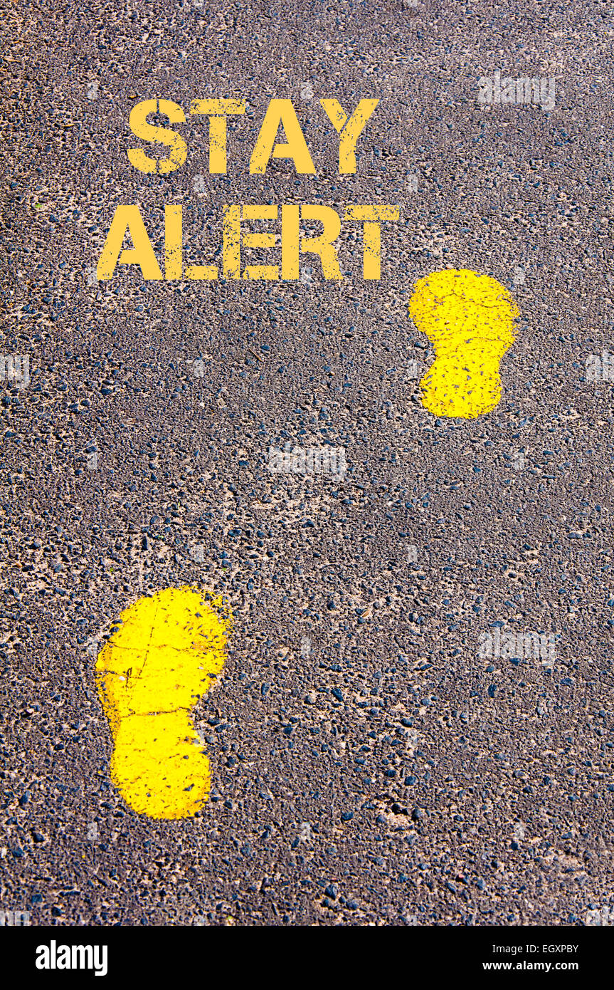 Yellow footsteps on sidewalk towards Stay Alert message.Conceptual ...
