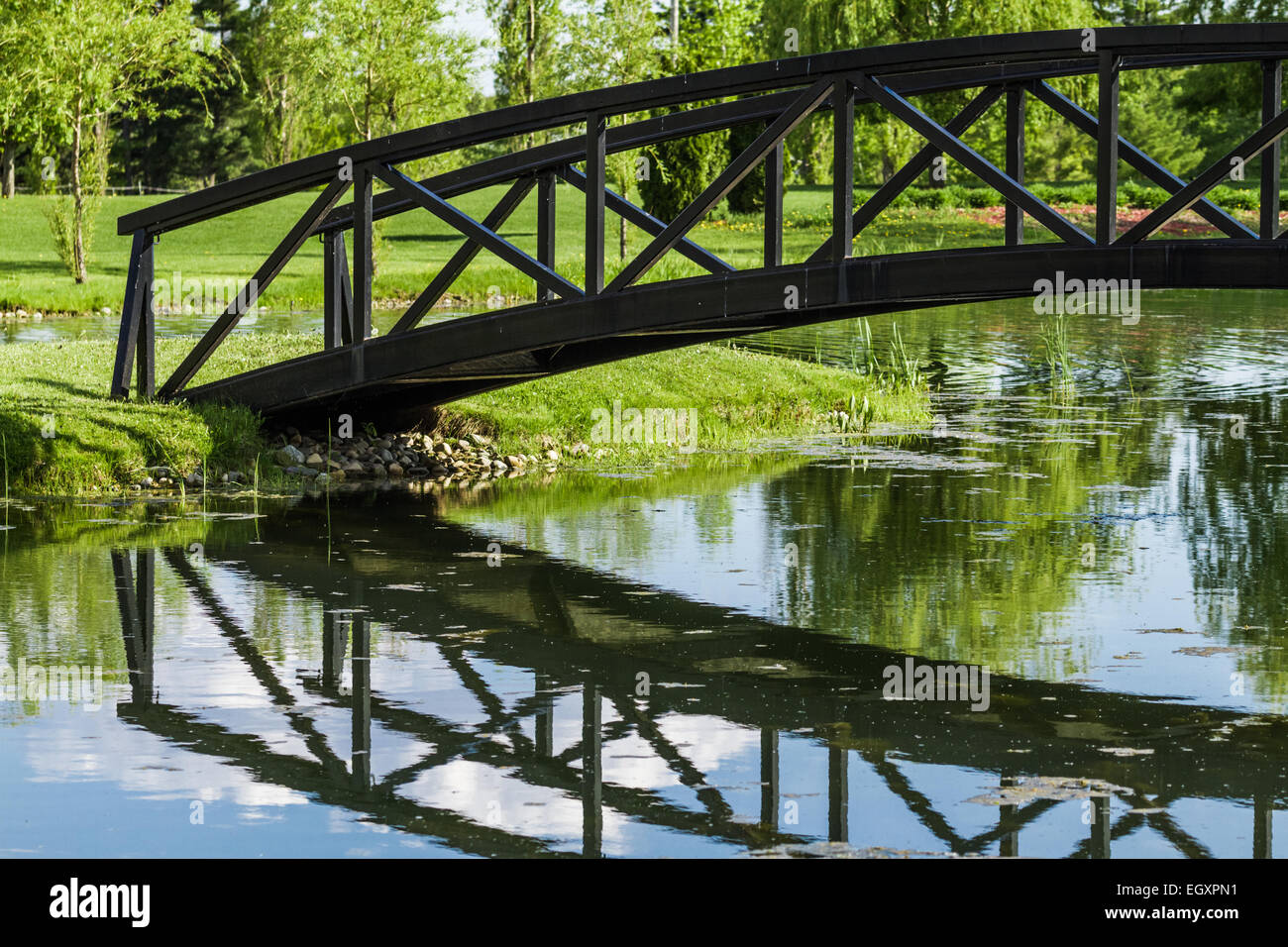 Little Bridge Over a Pond and landing on a Small Grass Island Stock ...