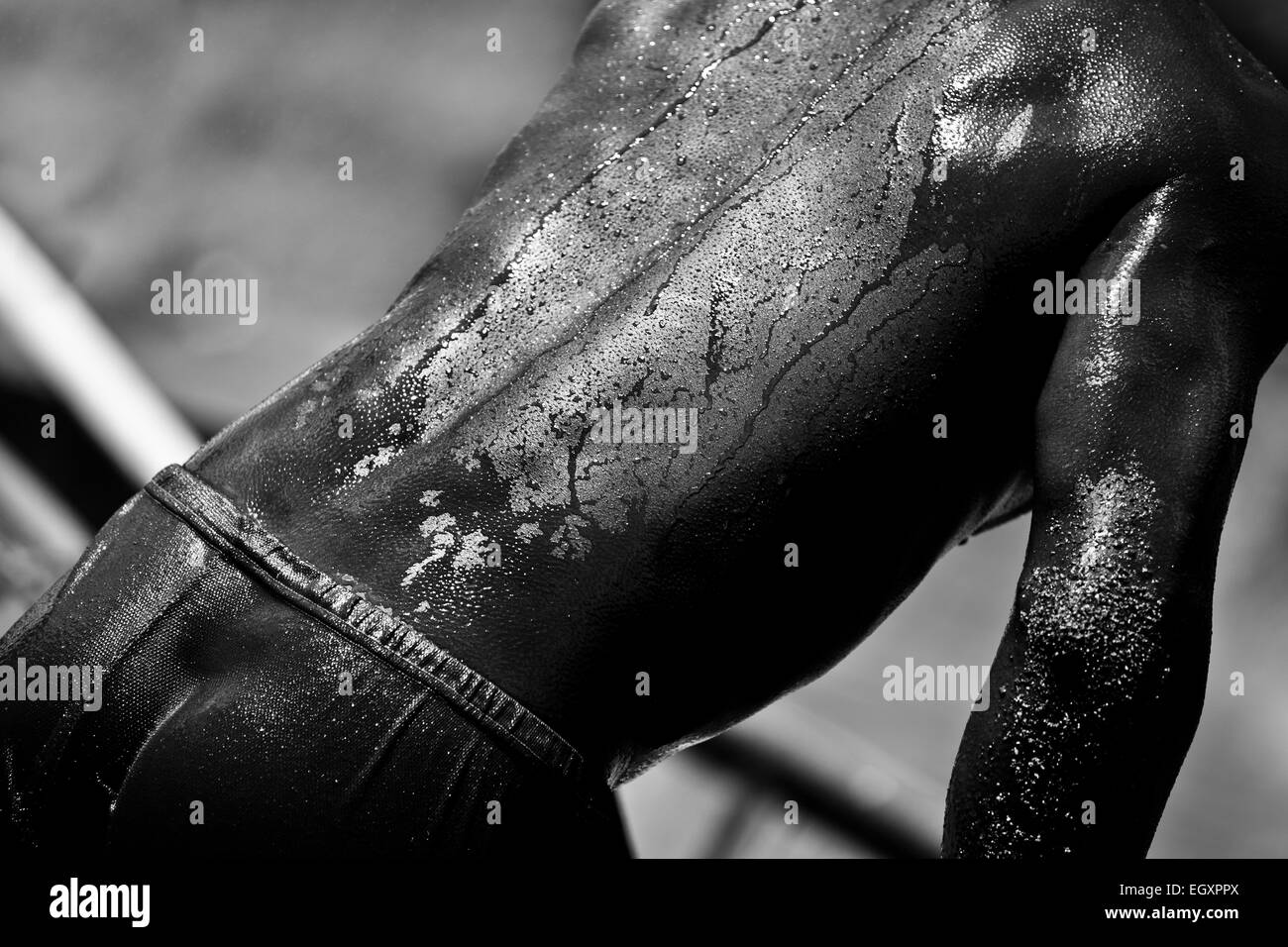 A Colombian sand miner climbs up the anchored boat while working in the ...