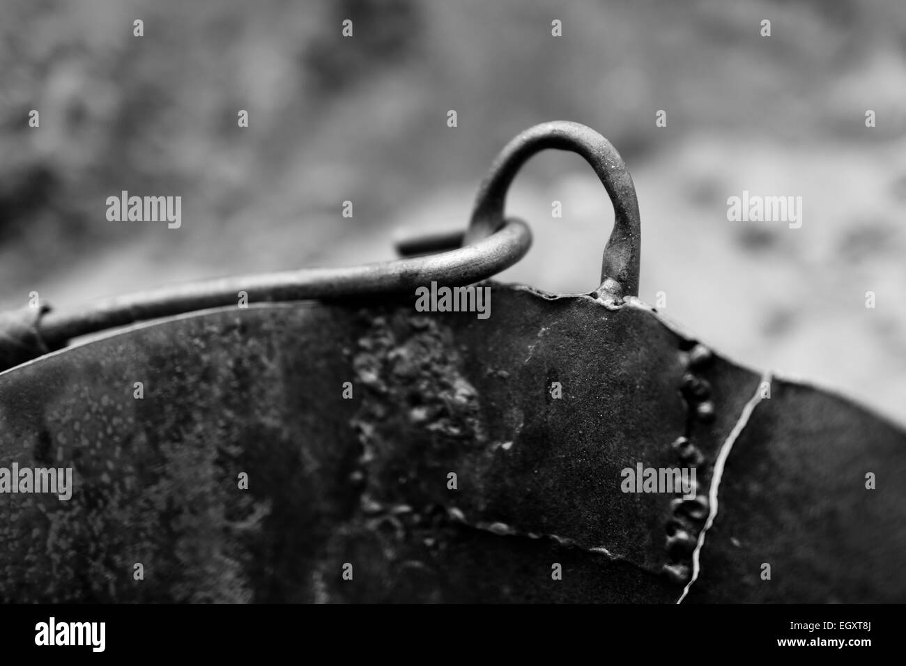A close-up view of a sand miner's bucket seen on the bank of the river ...