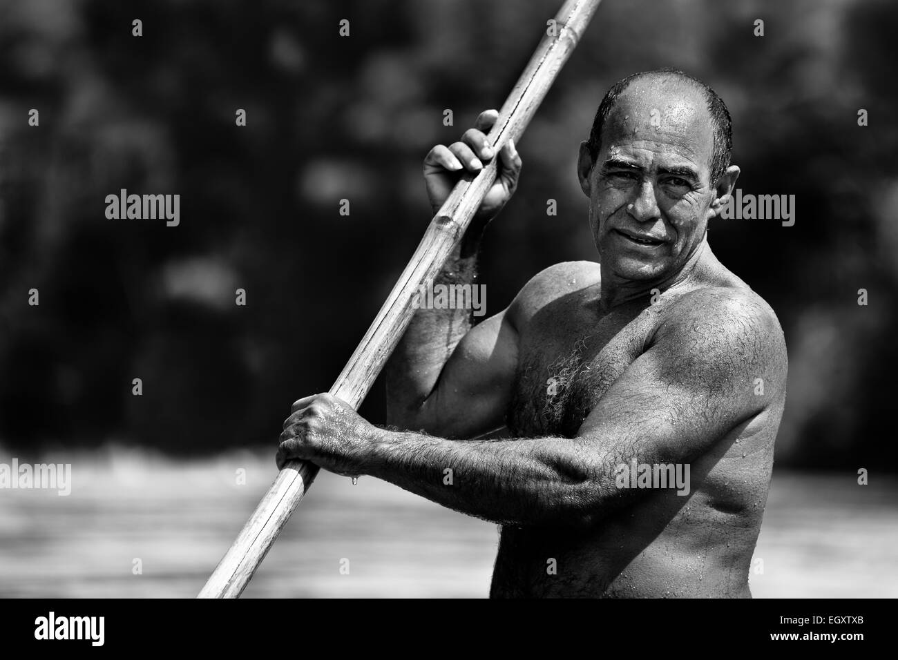 A Colombian sand miner, using a barge pole, navigates his boat in the ...