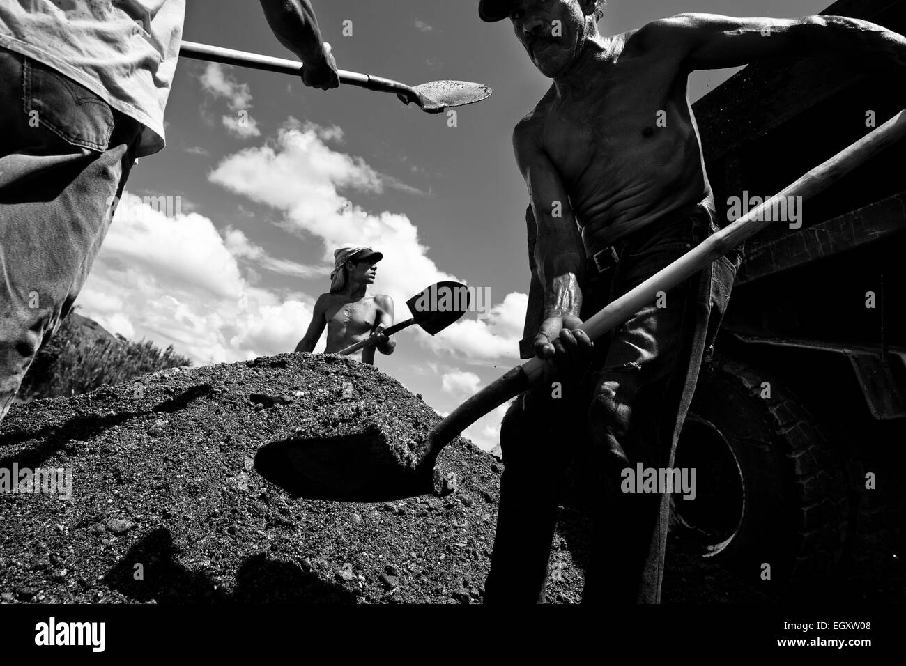 Colombian sand miner load the extracted sand into a car on the bank of ...