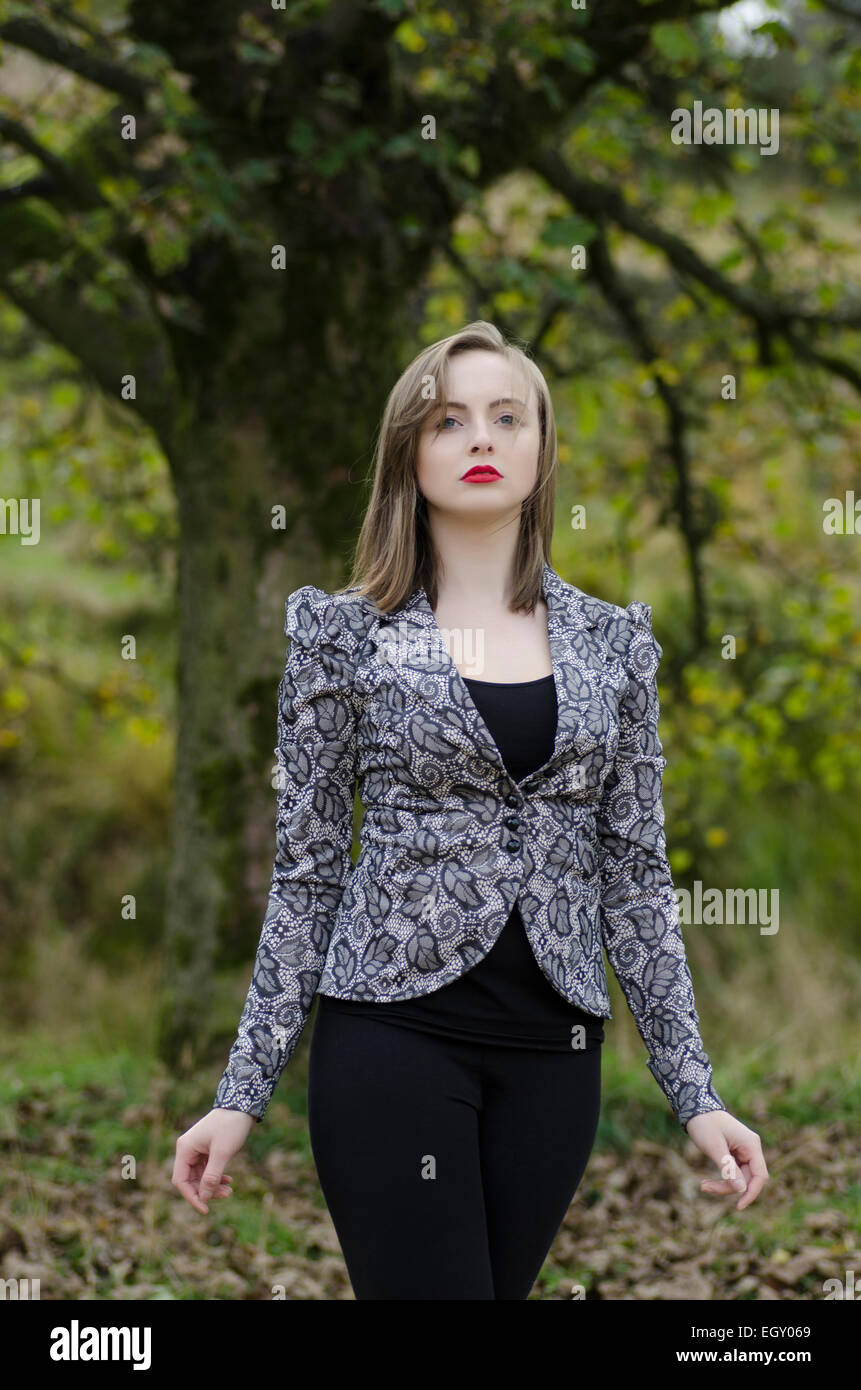 Beautiful young woman standing in the countryside Stock Photo - Alamy