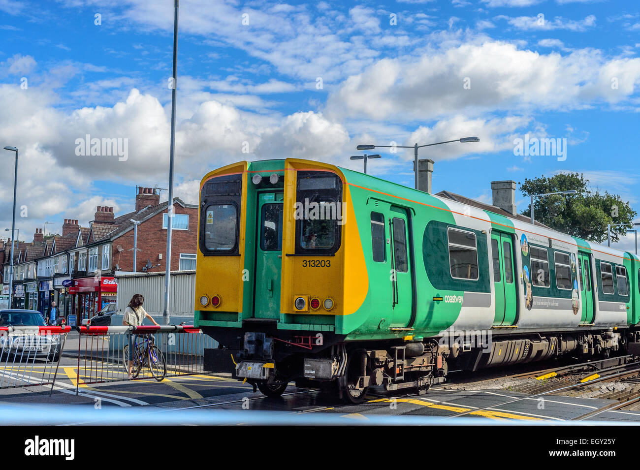 Train passing through a level crossing Stock Photo - Alamy