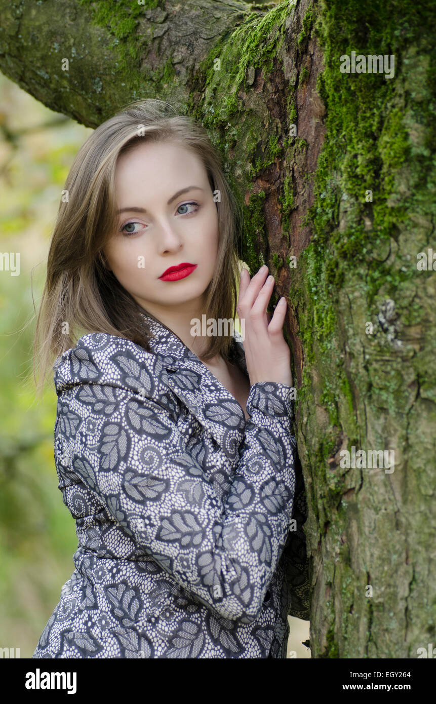 One woman standing against tree hi-res stock photography and images - Alamy