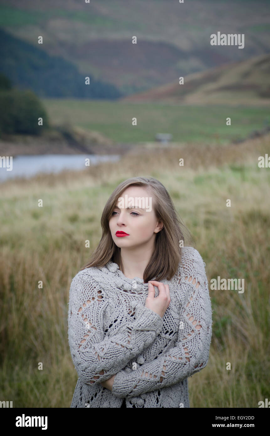 Beautiful young woman standing in the countryside looking away Stock ...