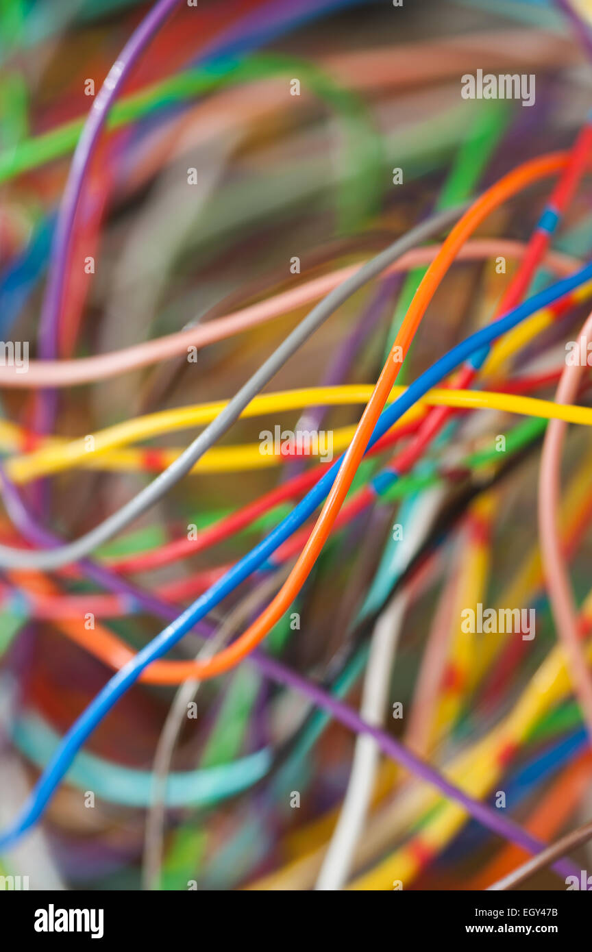 spaghetti junction mass of different colored network computer cables ...