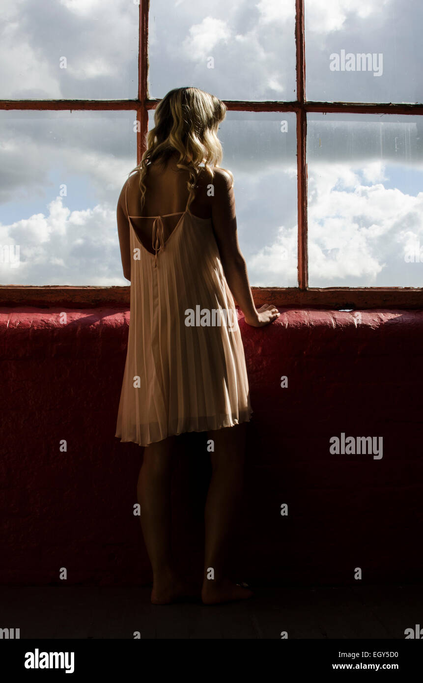 Rear view of woman looking back hi-res stock photography and images - Alamy